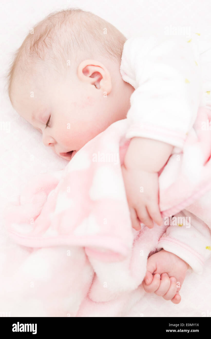 Cute baby girl sleeping in her crib Stock Photo - Alamy