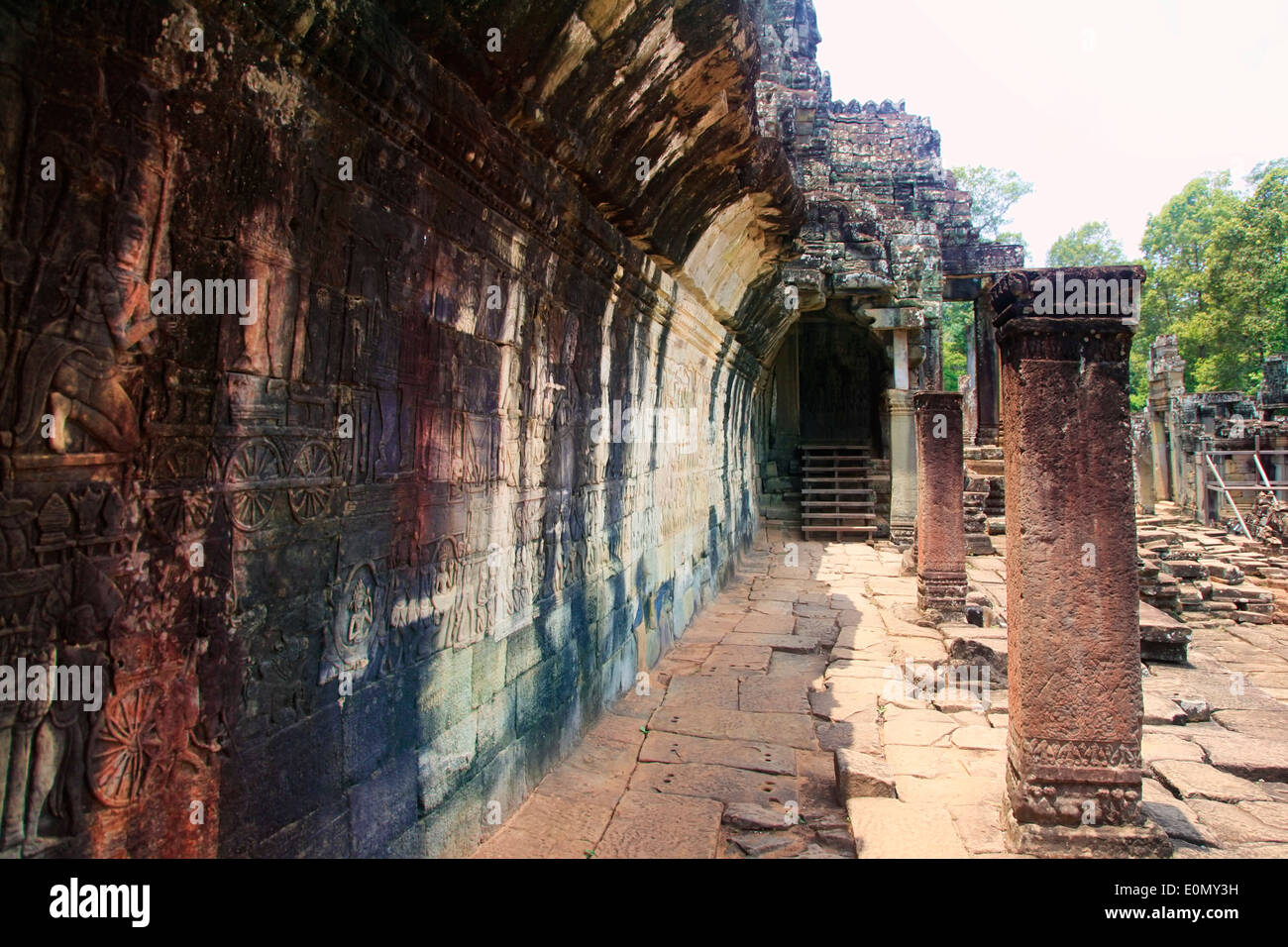 Long corridor of pillars in temple ruins. Bayon Temple of Angkor Thom ...