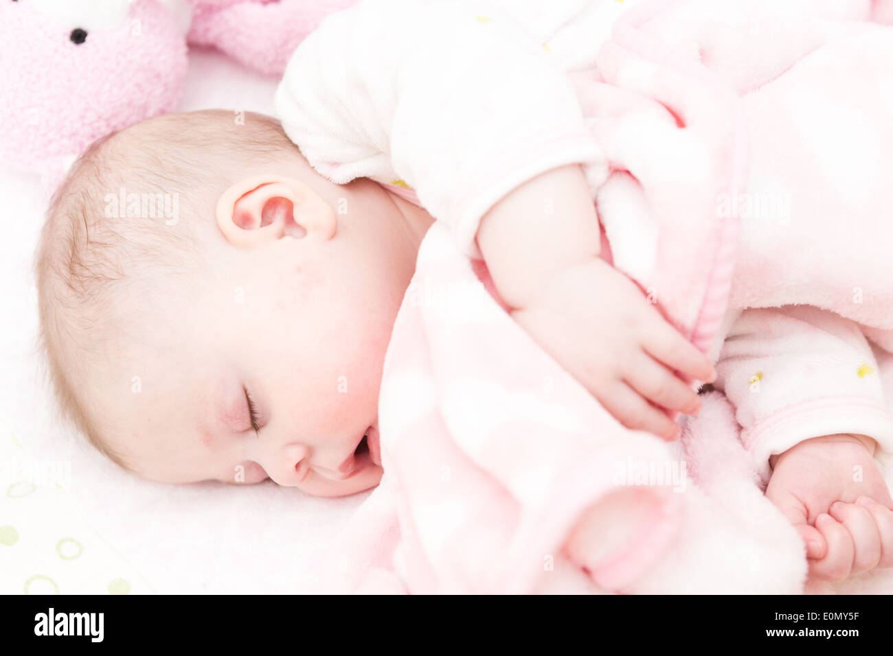 Cute baby girl sleeping in her crib Stock Photo - Alamy