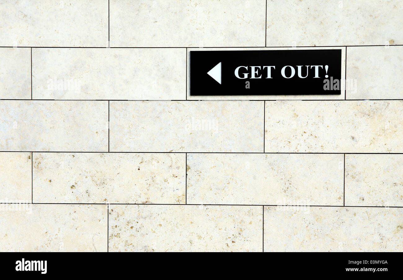 Black get out sign on the white wall Stock Photo - Alamy