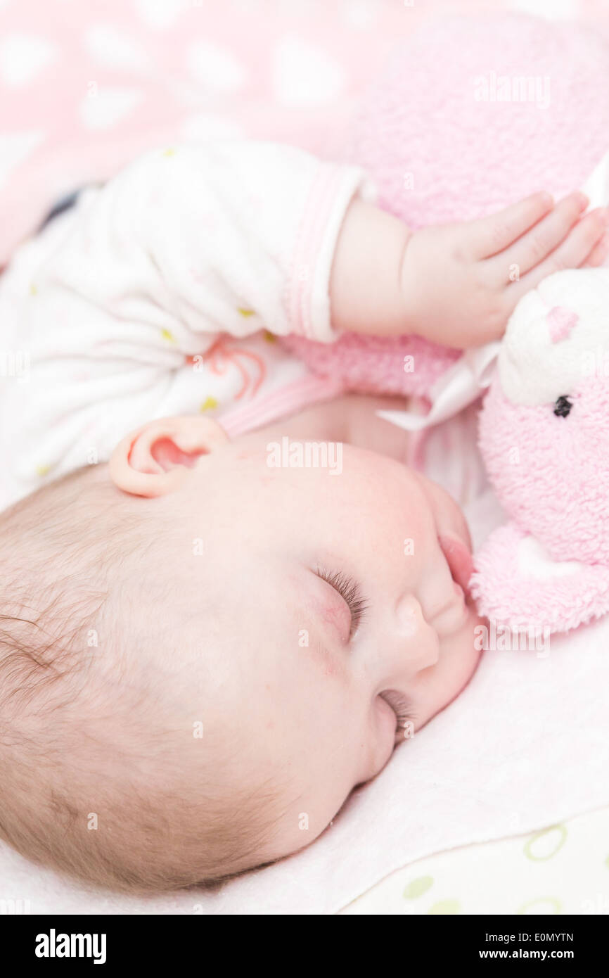 Cute baby girl sleeping in her crib Stock Photo - Alamy