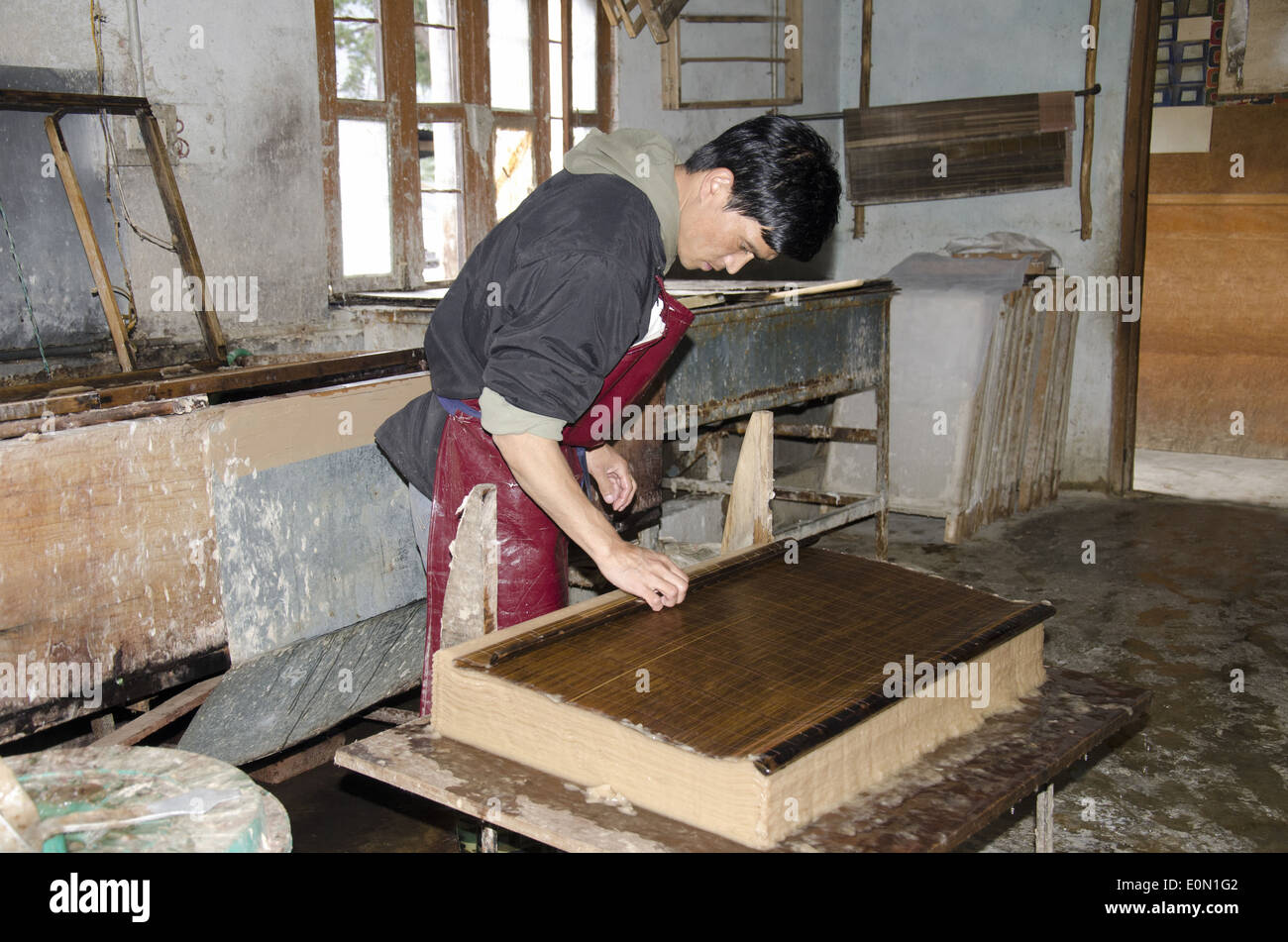 A man working in the Jungshi Paper Factory, Thimphu, Bhutan Stock Photo ...