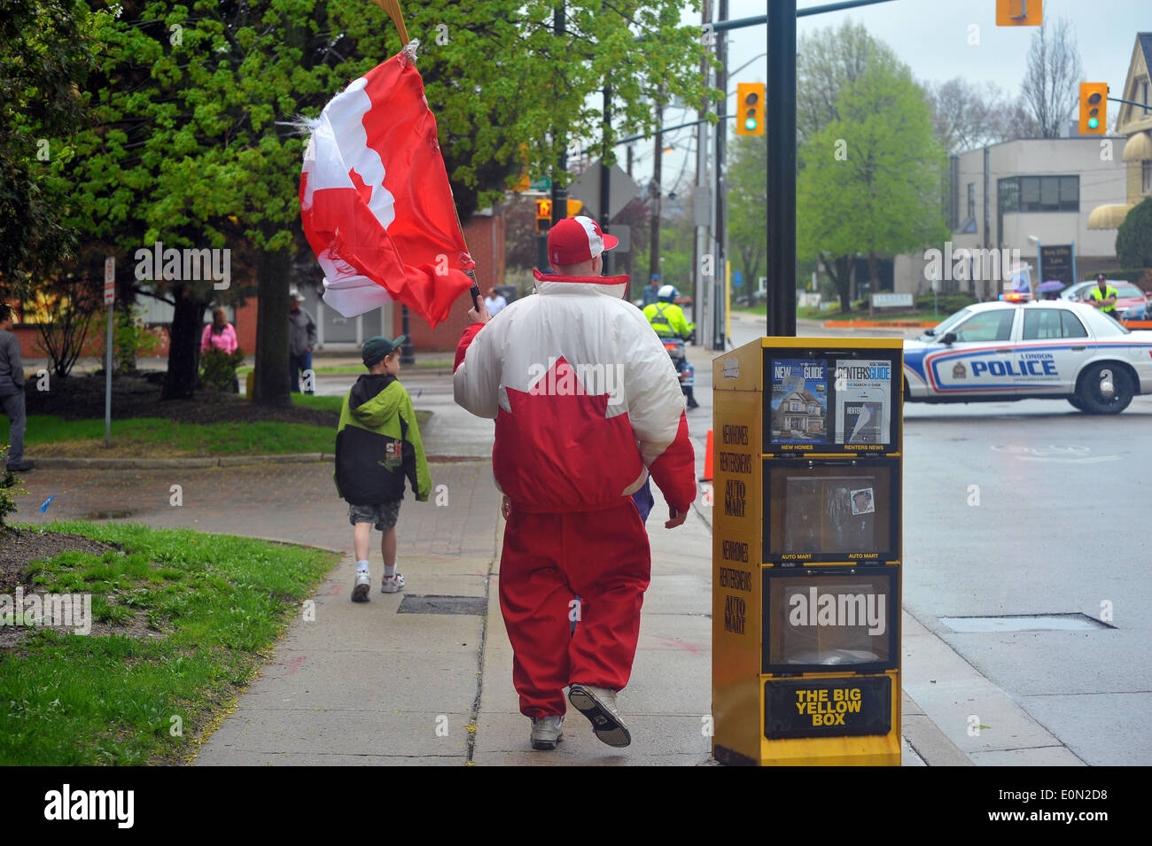 A Canadian Man waving a Canadian flag at a Memorial Cup parade Stock ...