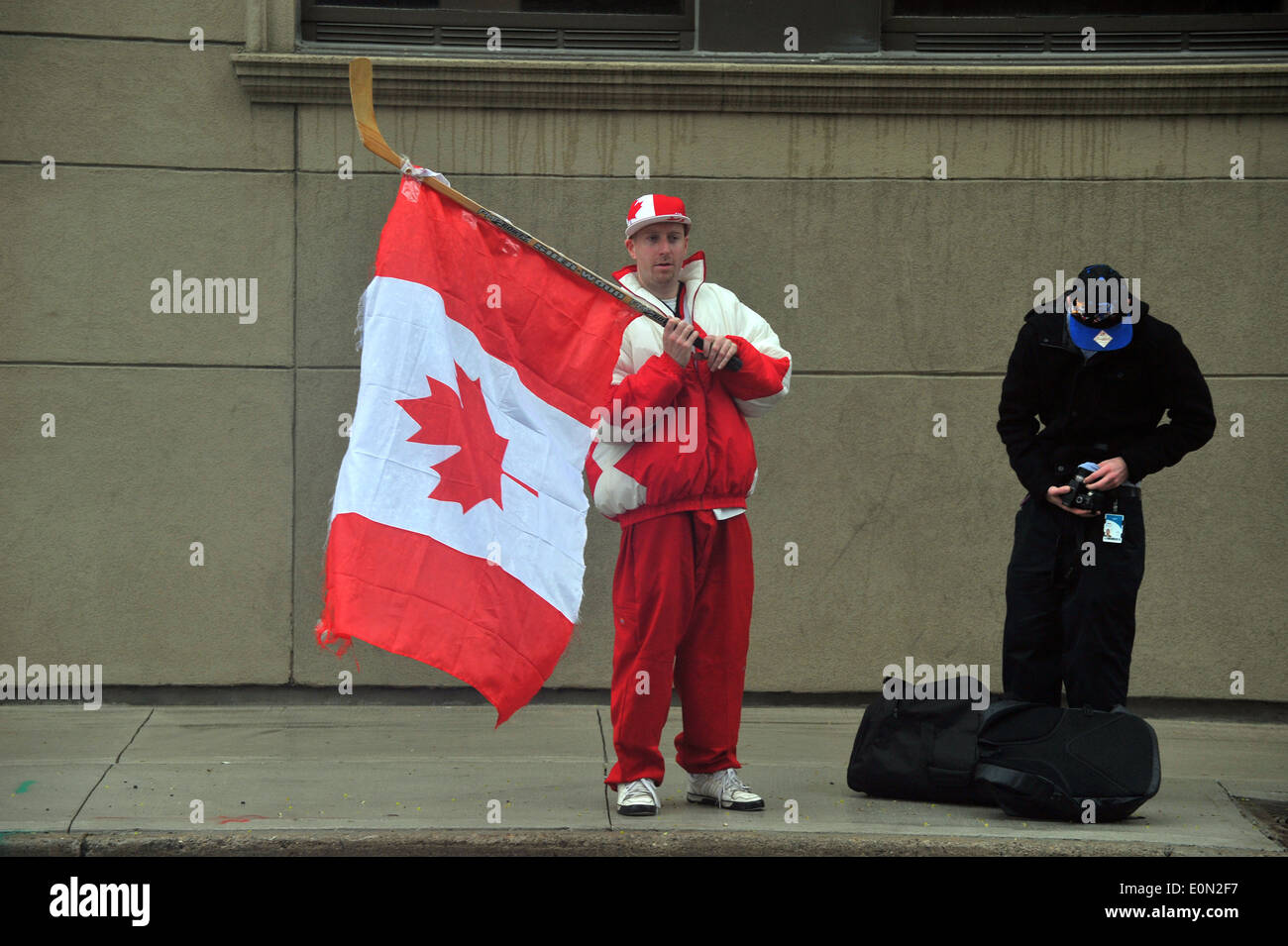 A Canadian Man waving a Canadian flag at a Memorial Cup parade Stock ...