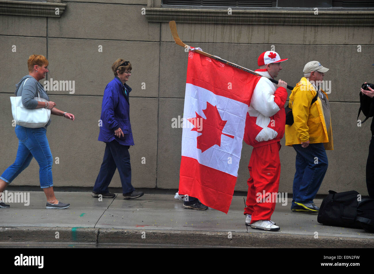 A Canadian Man waving a Canadian flag at a Memorial Cup parade Stock ...