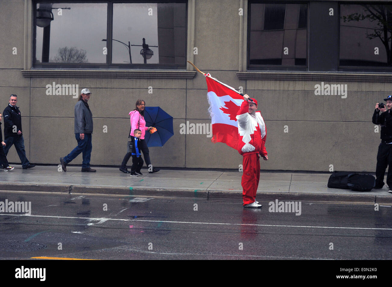 A Canadian Man waving a Canadian flag at a Memorial Cup parade Stock ...
