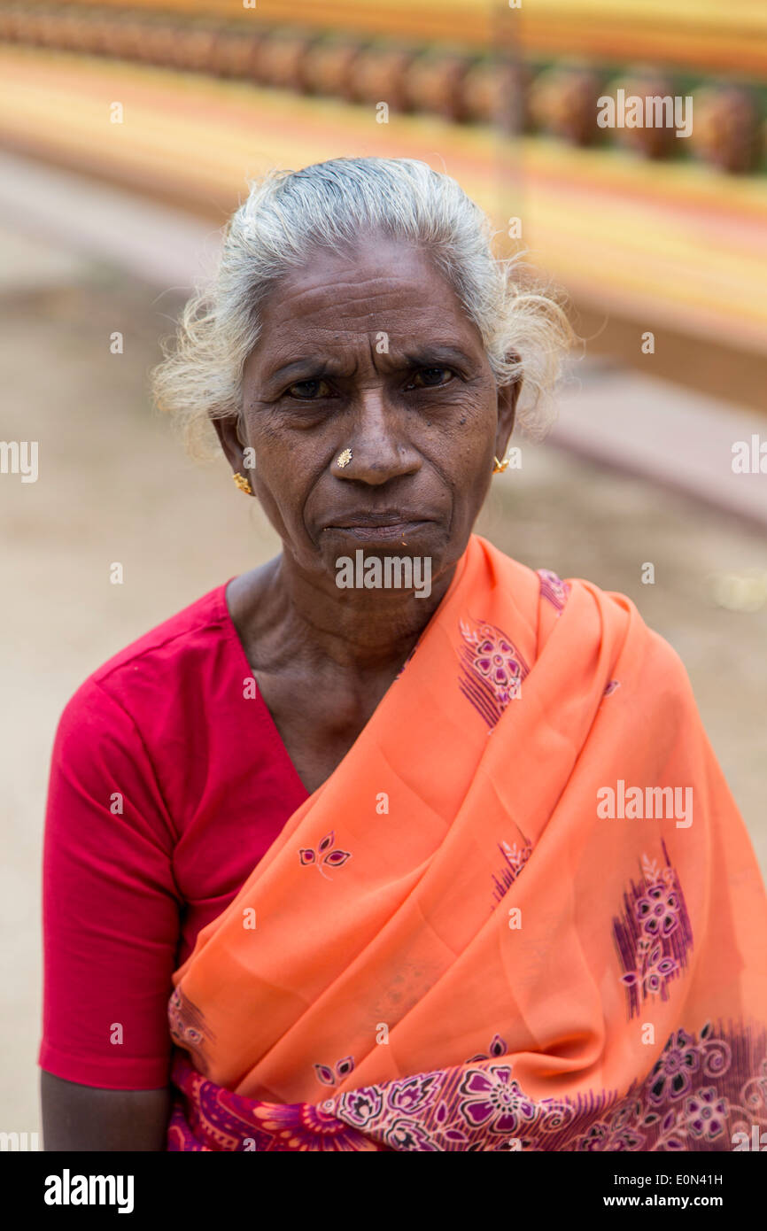 Woman in front of hindu temple Sri Muthumariamman Thevasthanam at ...