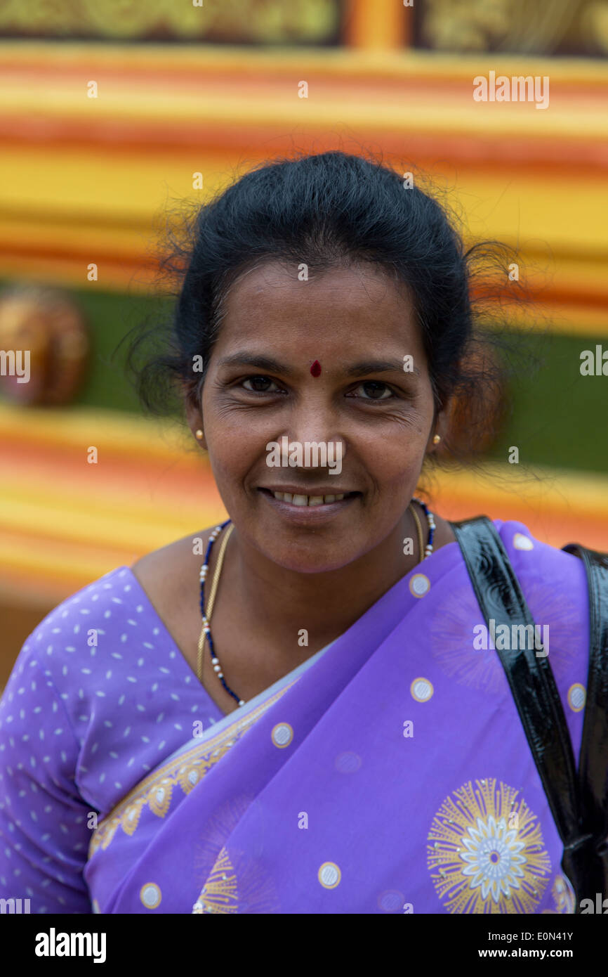 Woman in front of hindu temple Sri Muthumariamman Thevasthanam at ...