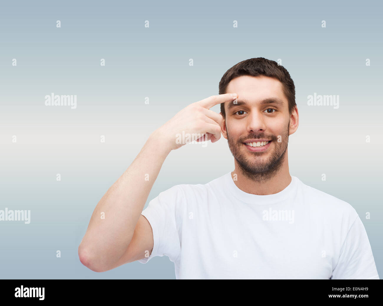 smiling young handsome man pointing to forehead Stock Photo - Alamy