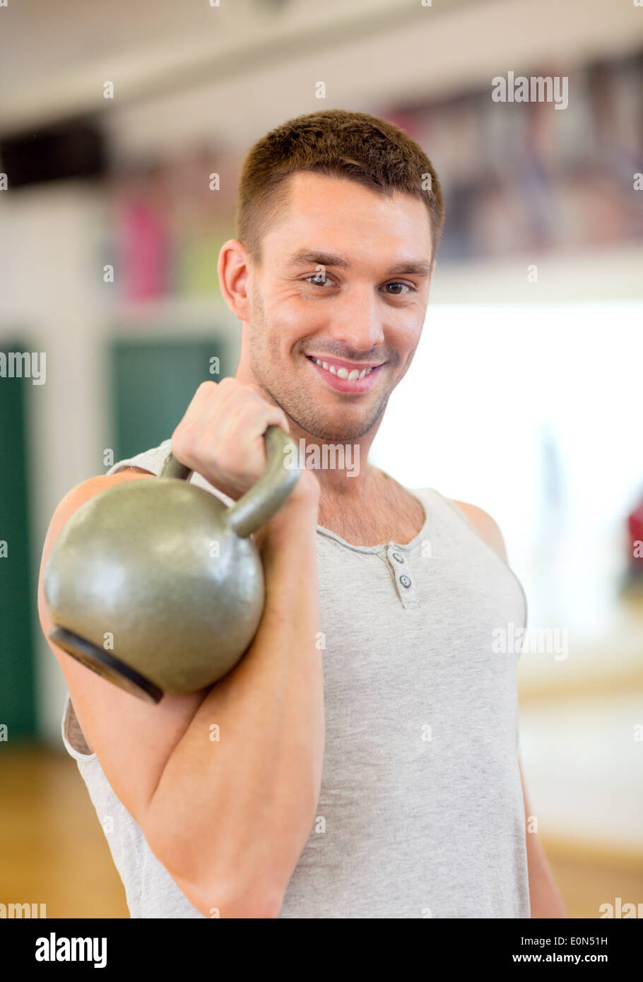Muscular man lifting heavy kettlebell hi-res stock photography and ...