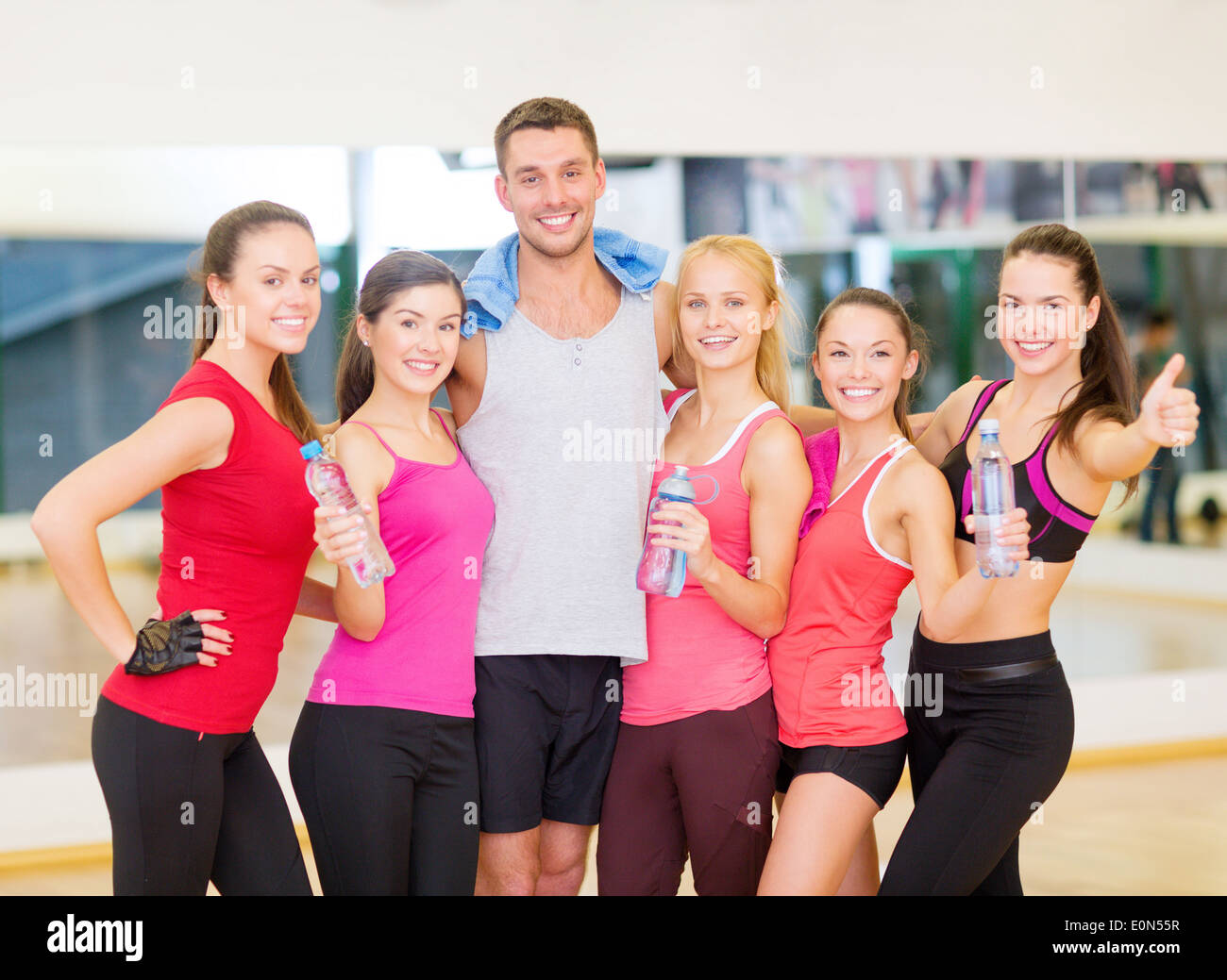group of happy people in gym with water bottles Stock Photo - Alamy