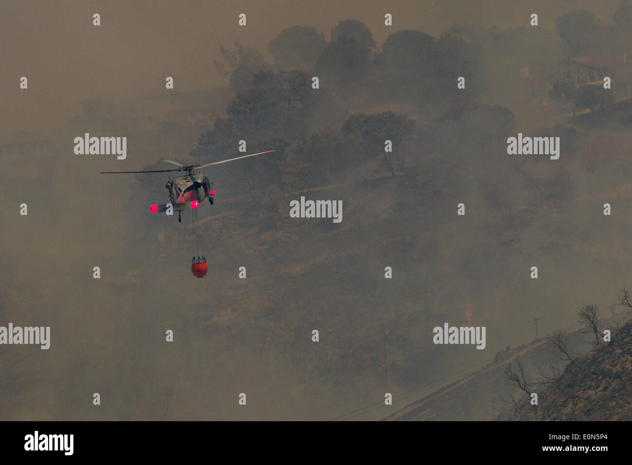 A US Marine Corps HH-60H Sea Hawk helicopter carries a monsoon bucket ...