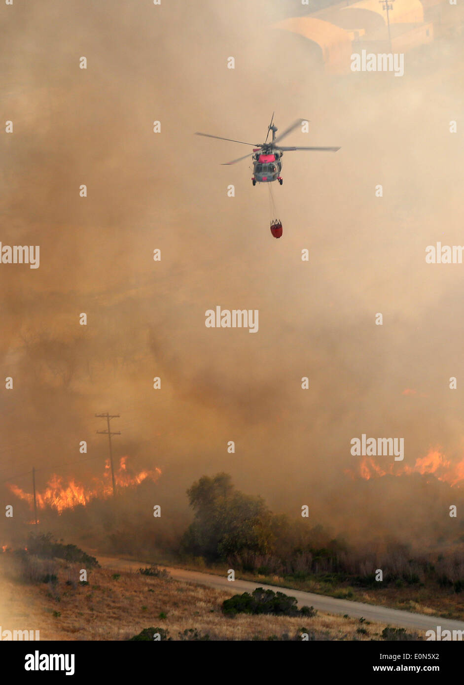 A US Marine Corps HH-60H Sea Hawk helicopter drops a monsoon bucket ...