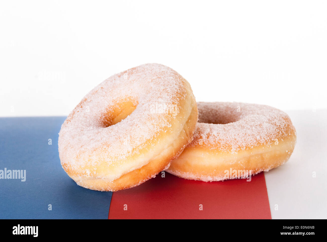 Two Donuts on a blue, red, white Background, Isolated Stock Photo - Alamy