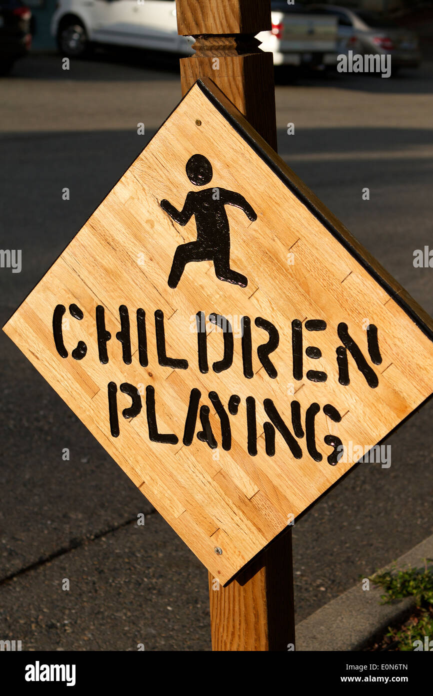Wooden Children playing warning sign Stock Photo - Alamy