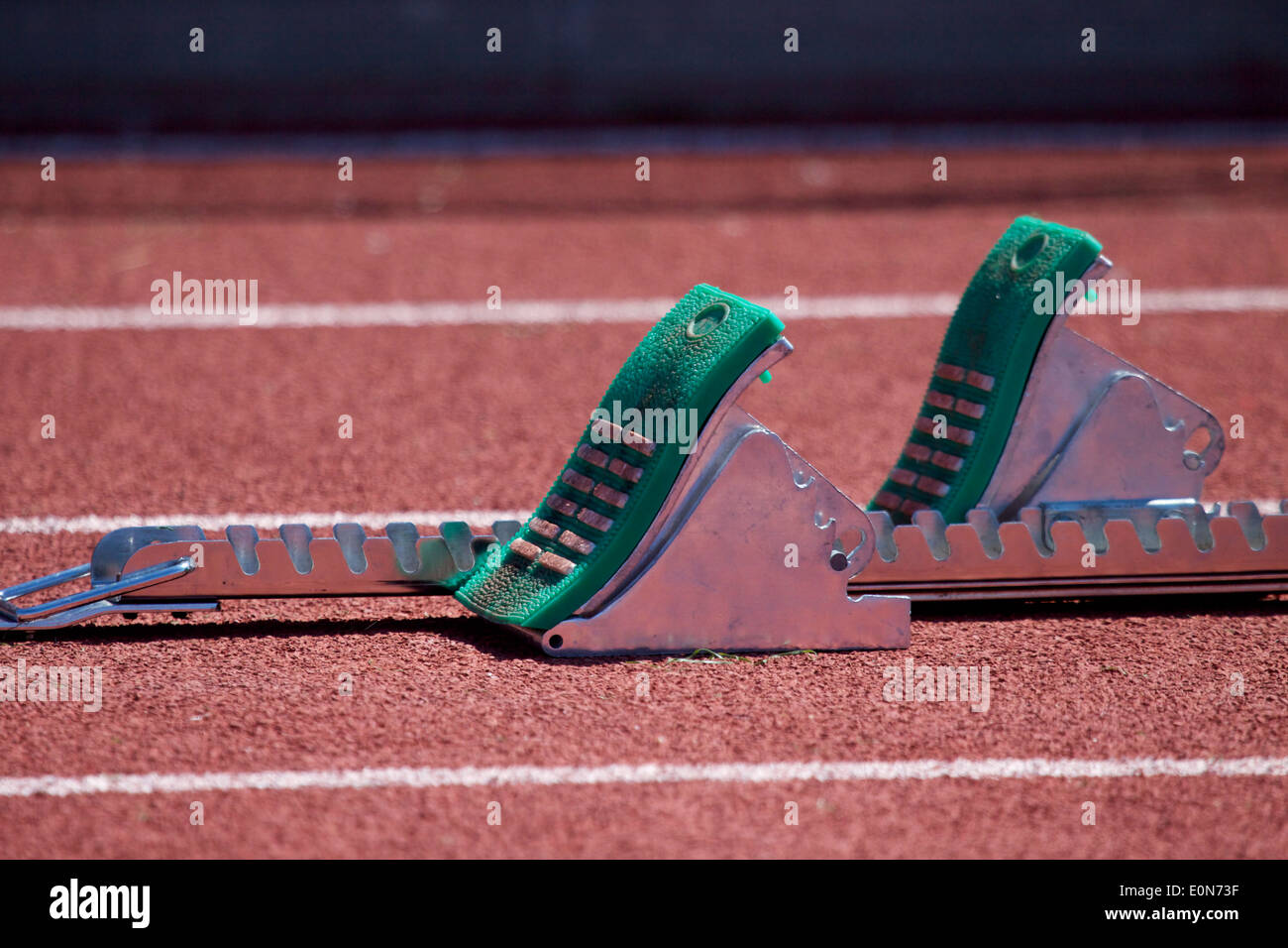 Starting blocks on a running track Stock Photo - Alamy