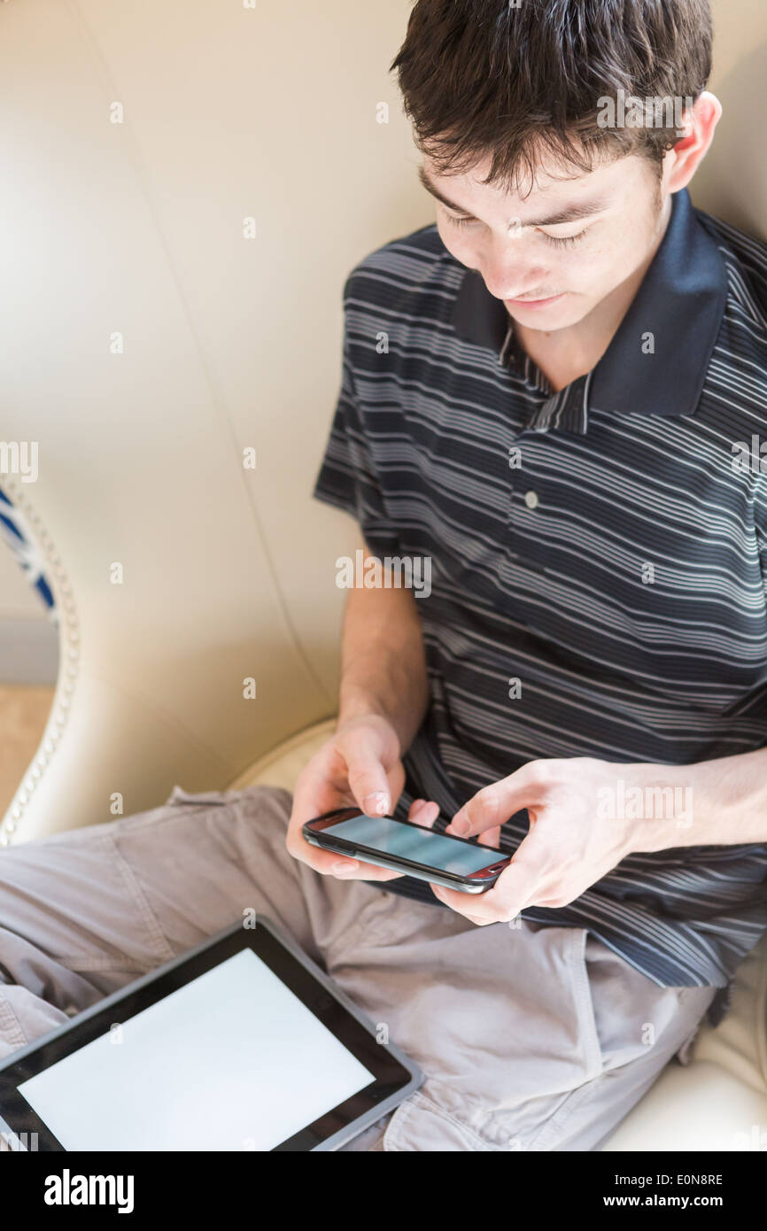 Teenage boy playing with his computer gadgets at leisure time Stock ...