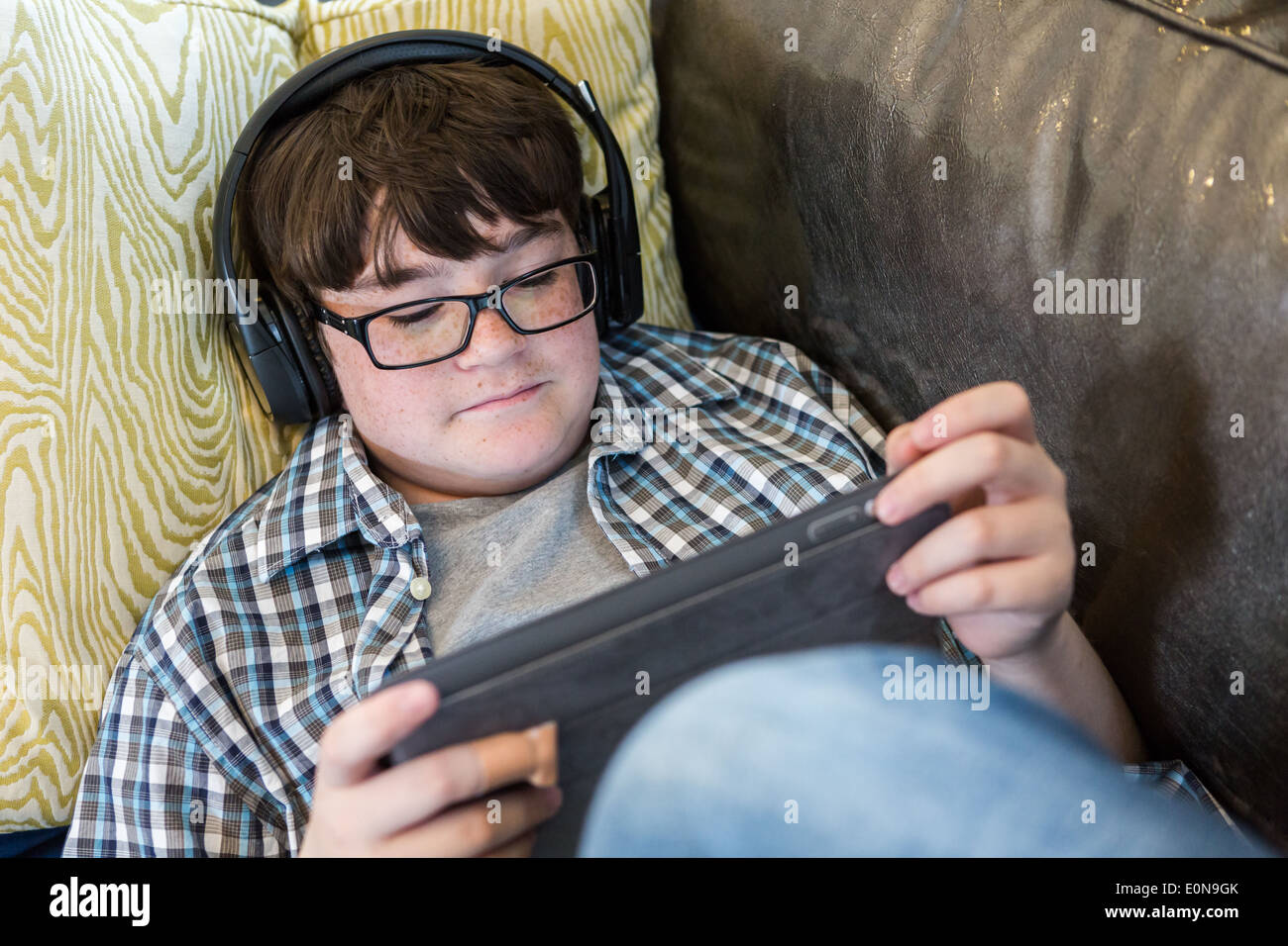 Teenage boy playing with his computer gadgets at leisure time Stock ...