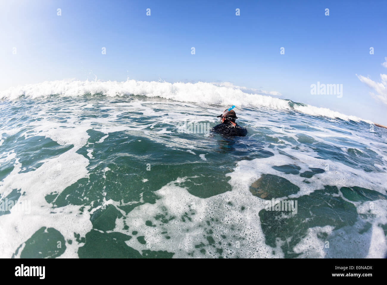 Diver unidentified diving in ocean waves sea water shallow reefs ...