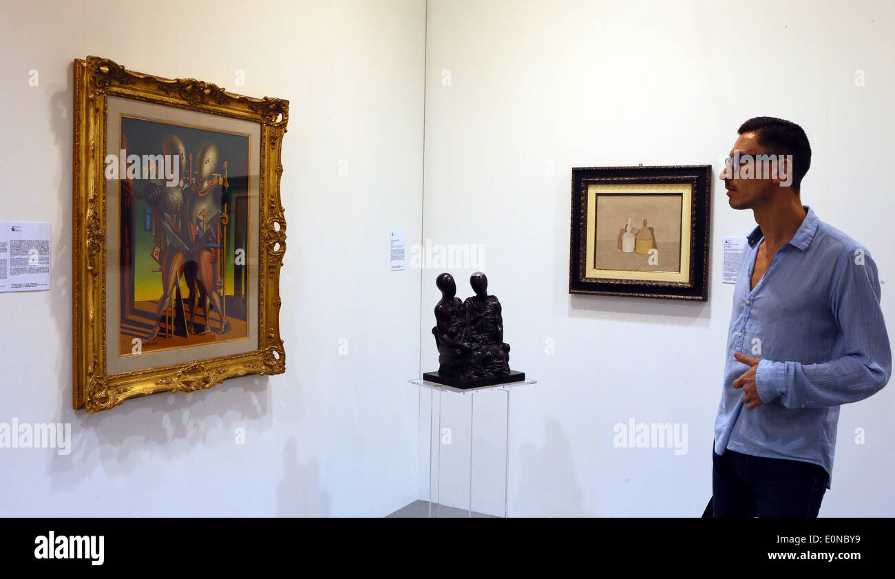 Hong Kong, China. 16th May, 2014. A visitor looks at a work by Italian ...