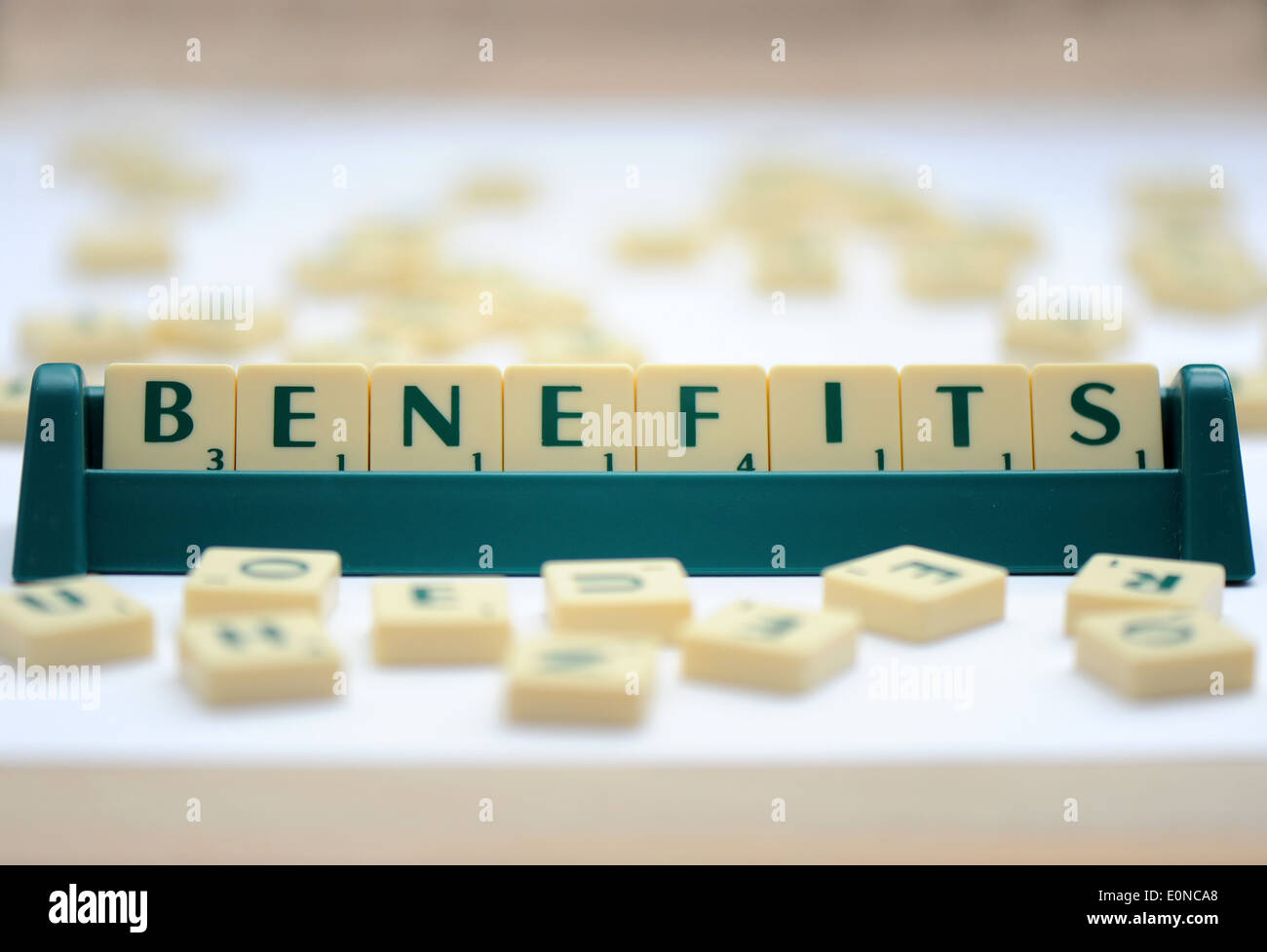 Scrabble tiles reading out the words benefits Stock Photo - Alamy