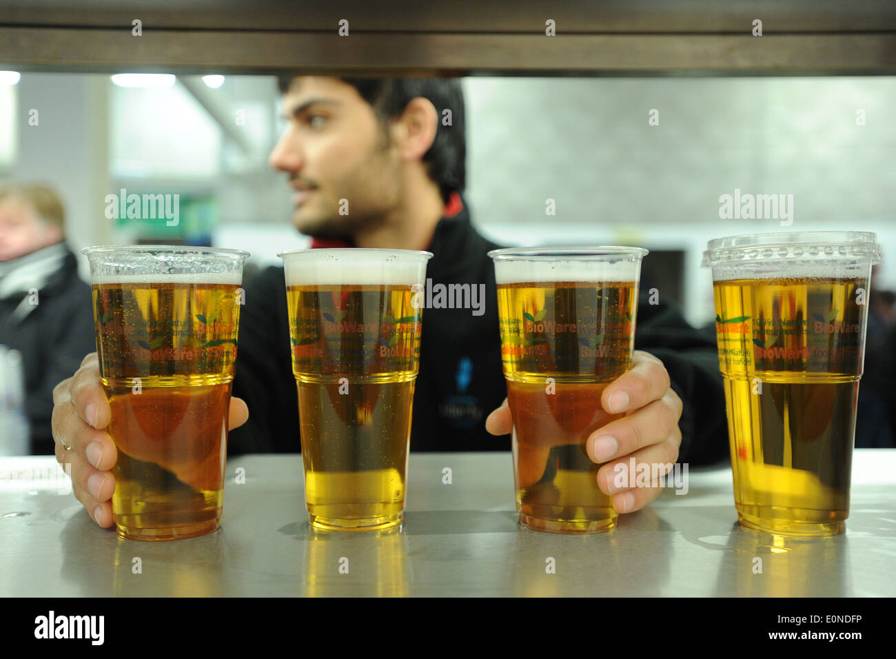 A bar worker picks up pints of beer in a bar Stock Photo - Alamy