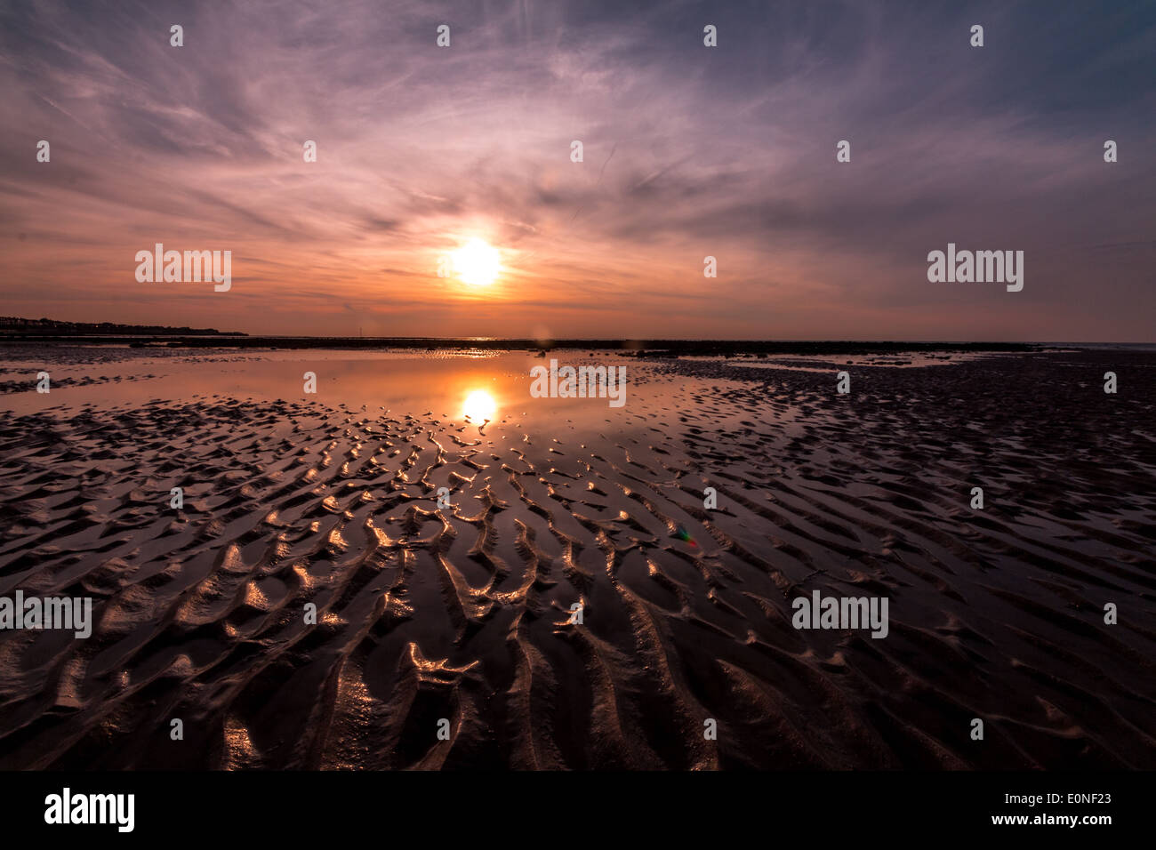 Sunset over beach Stock Photo - Alamy