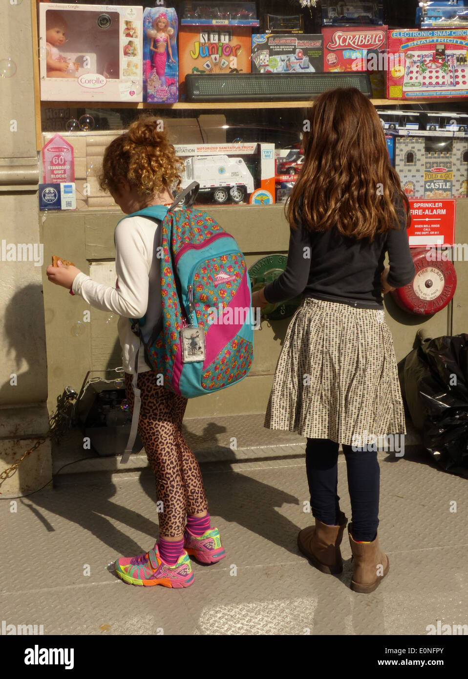 Two children looking in a shop window Stock Photo - Alamy