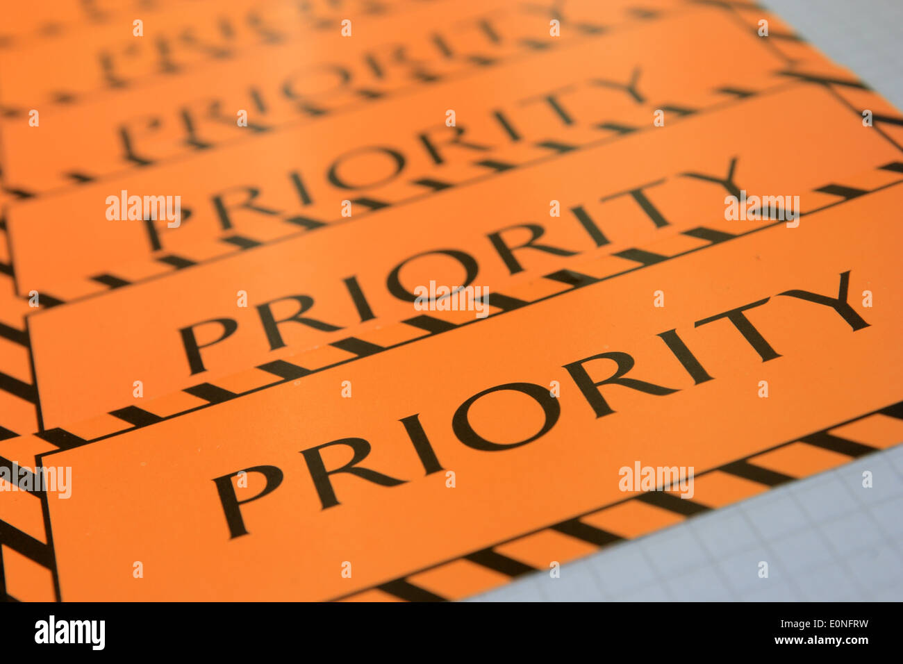orange-colored label priority for baggage Stock Photo - Alamy