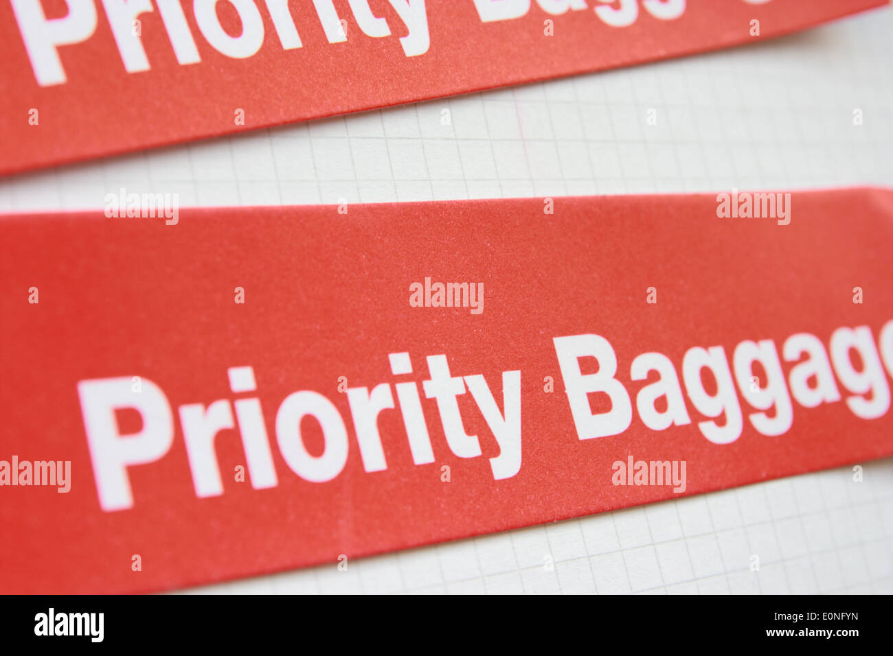 Red label priority for baggage Stock Photo - Alamy