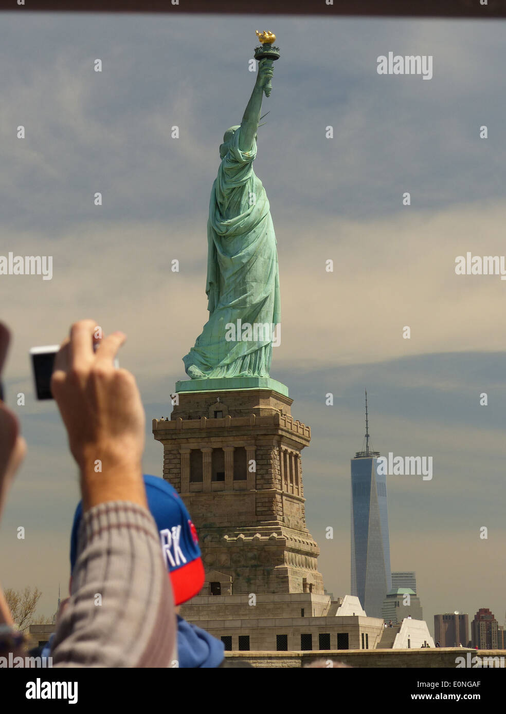 Tourists photographing the Statue of Liberty from the Statue Cruises ...