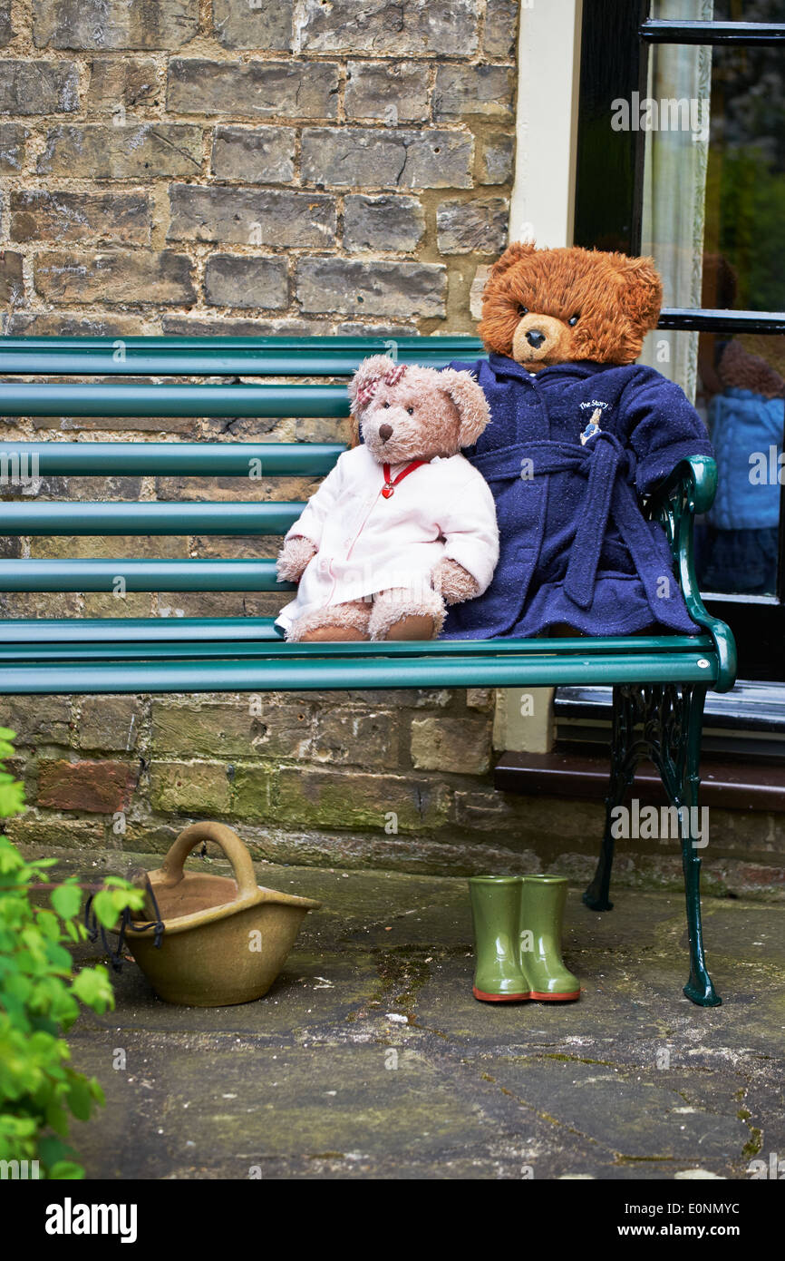 Teddy bears resting on garden seat Stock Photo - Alamy