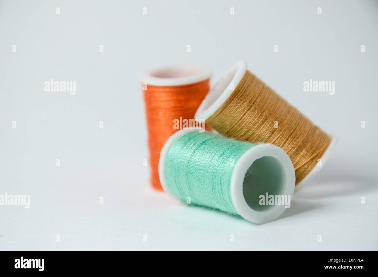 Three thread rolls against white background Stock Photo - Alamy