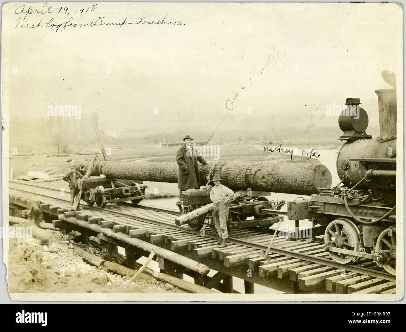 A historical photograph showing the first log from a timber dump ...