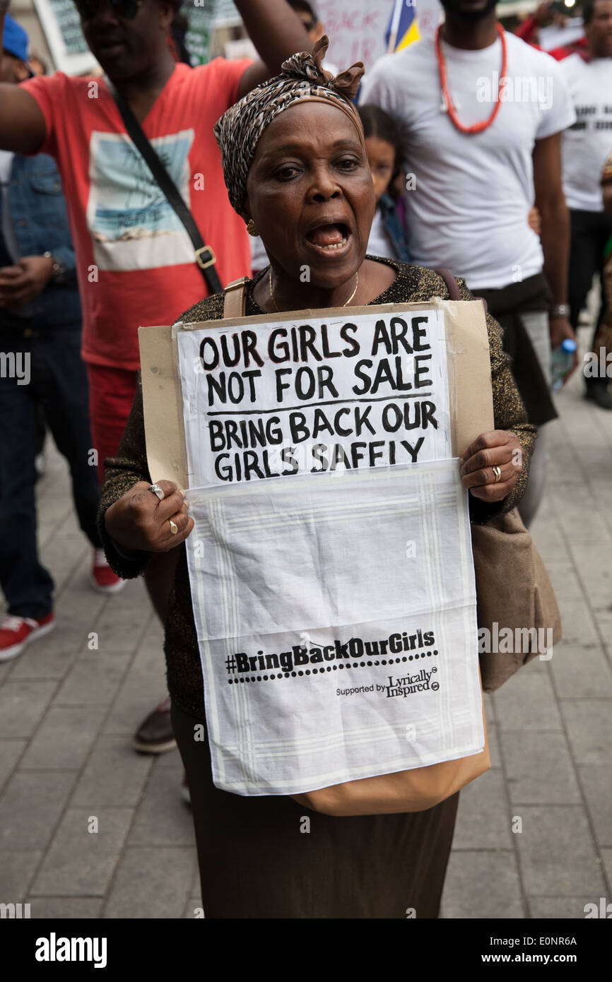 Woman protesting for the campaign "Bring back our girls", holding board ...