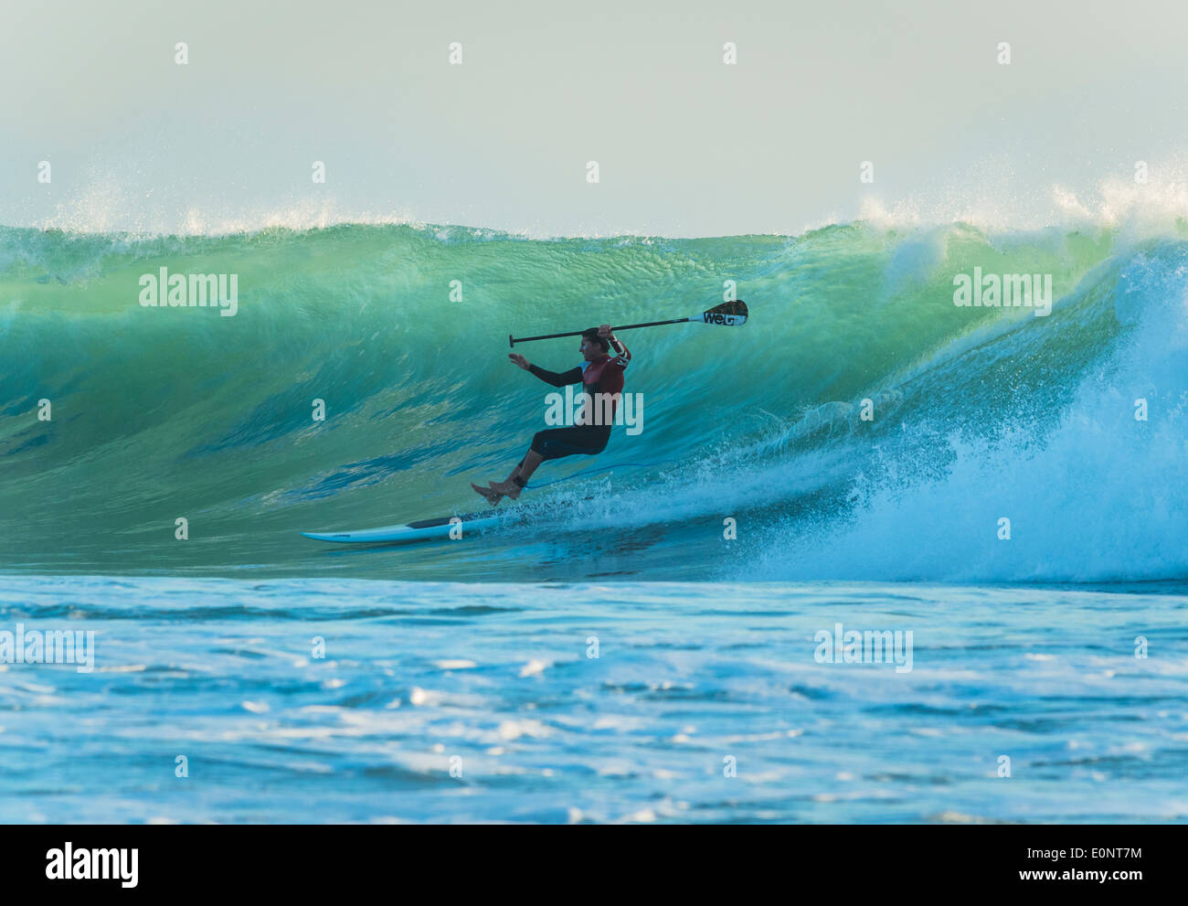 Paddle surfer falling down a wave Stock Photo - Alamy
