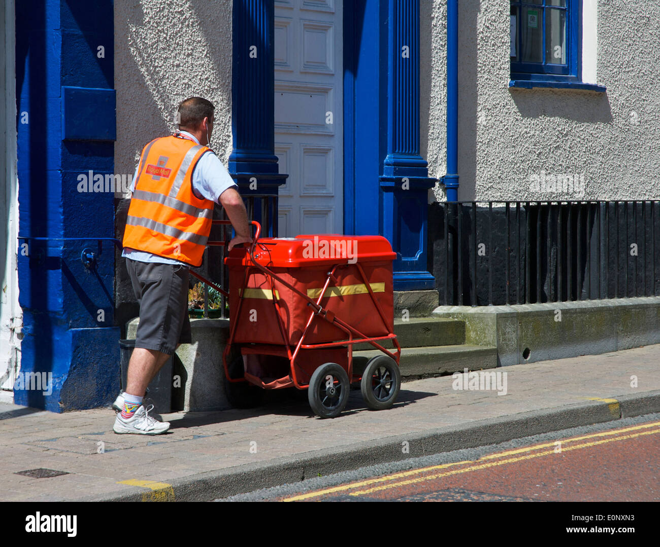Postman delivering mail Stock Photo - Alamy