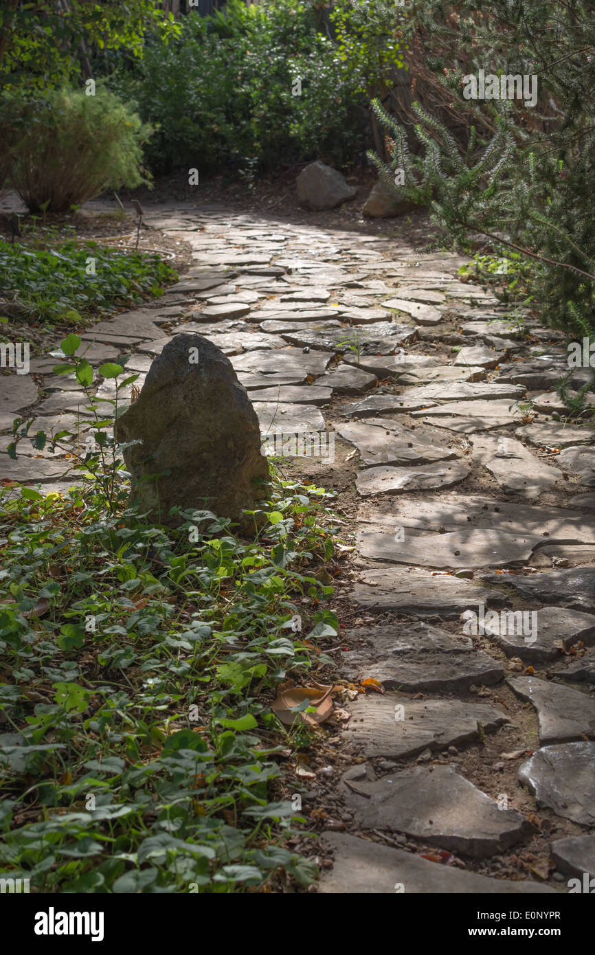 Merging stone paths in sunny meditative, zen like garden. Mallorca ...