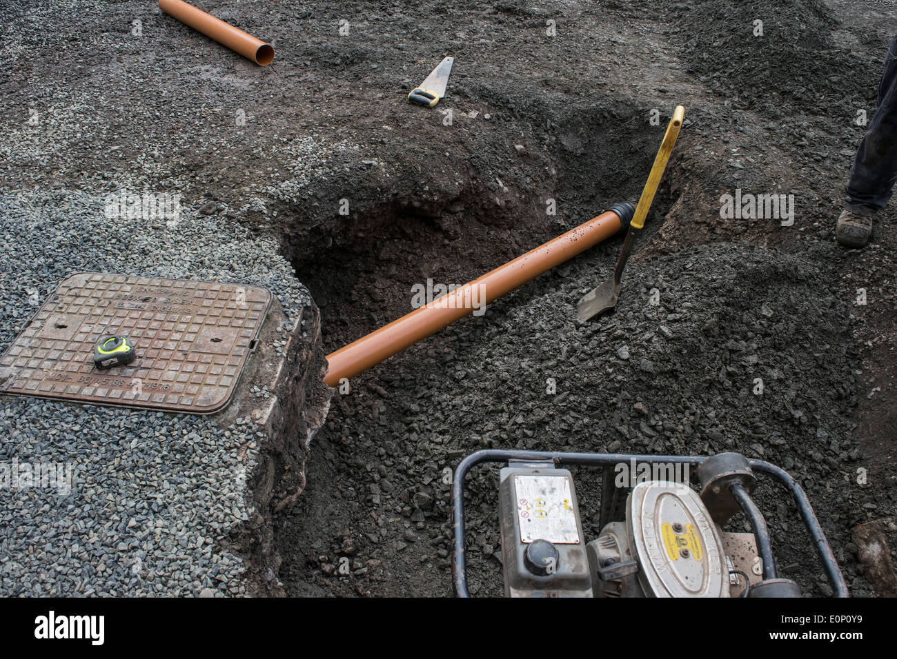 Laying a new plastic sewage drain pipe Stock Photo - Alamy