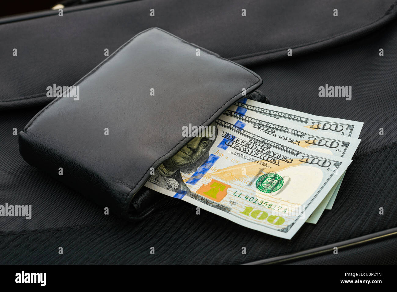 A black leather wallet with Dollar banknotes Stock Photo - Alamy