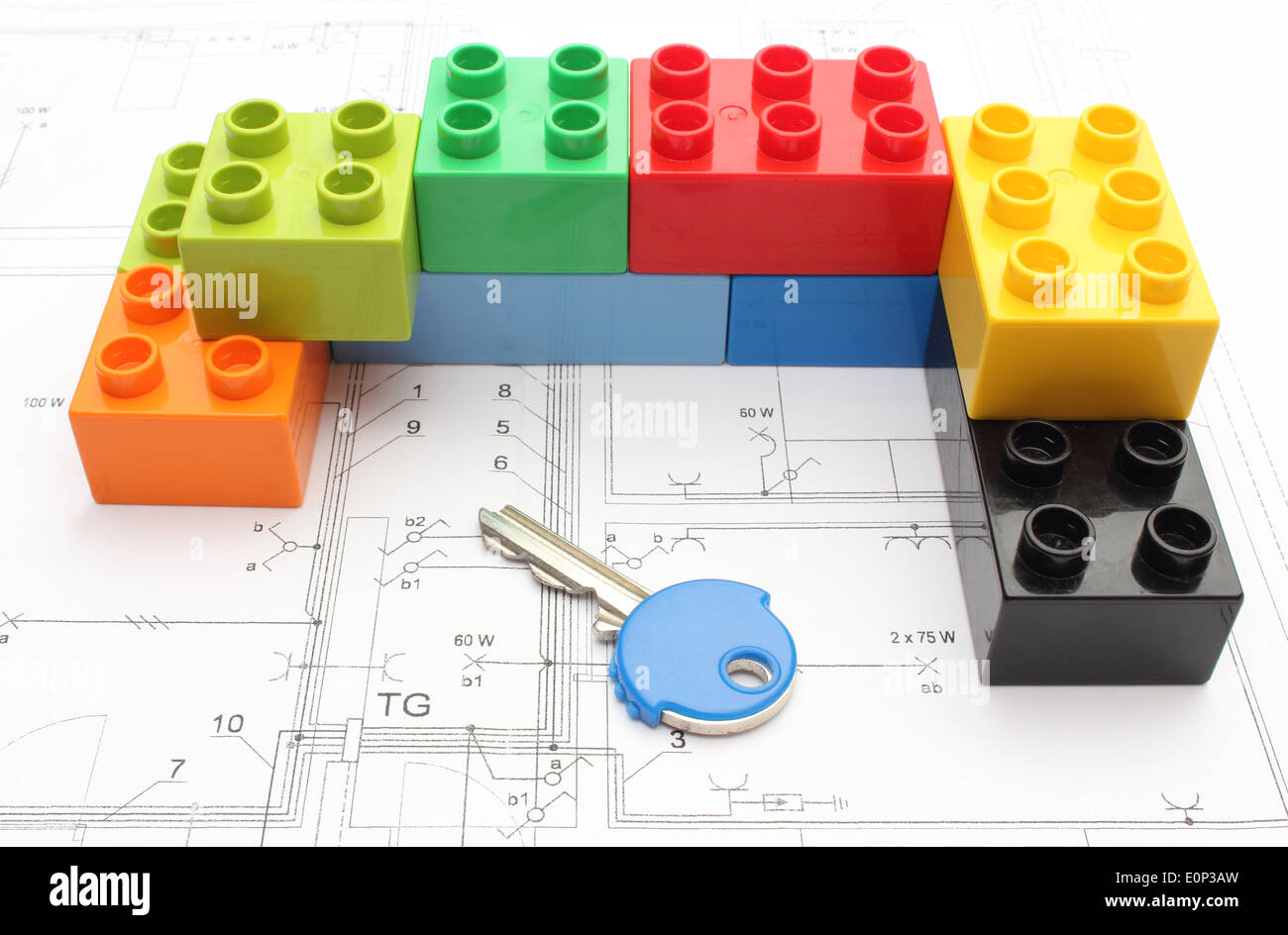 Colorful building blocks and key lying on construction drawing of house ...