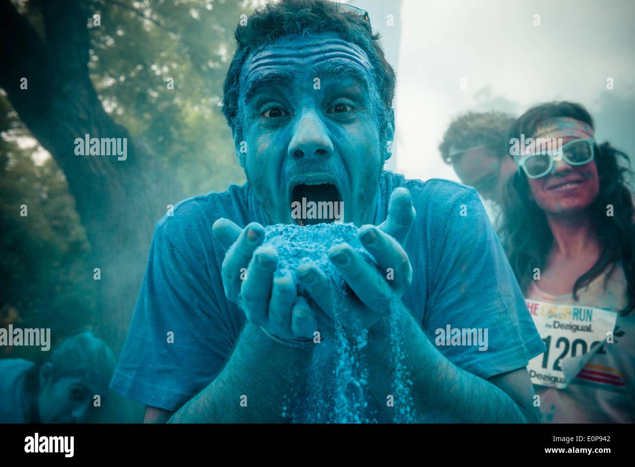 Barcelona, Spain. May 18th, 2014: A volunteer poses with blue colored ...