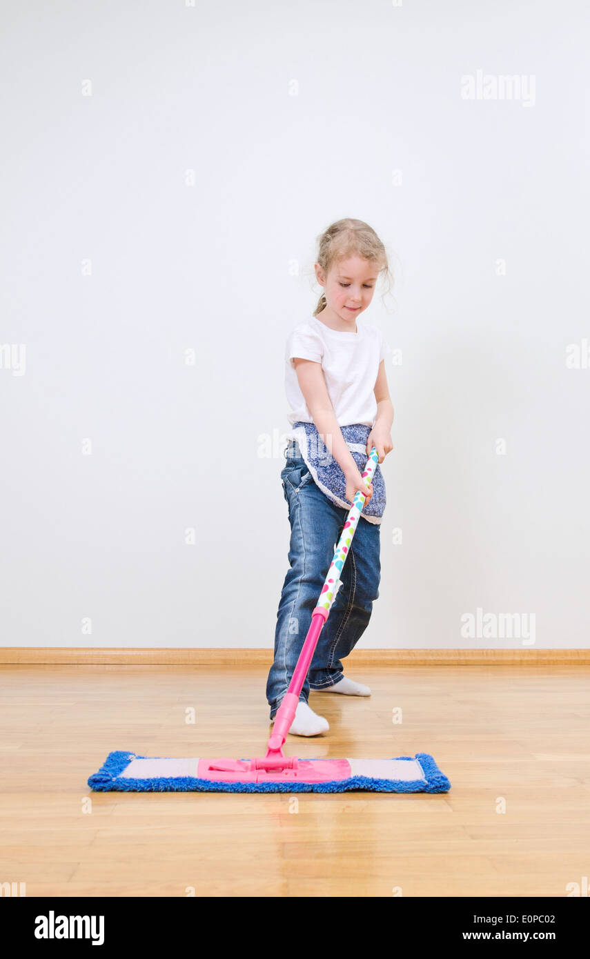 Little cute girl mopping floor at home Stock Photo - Alamy