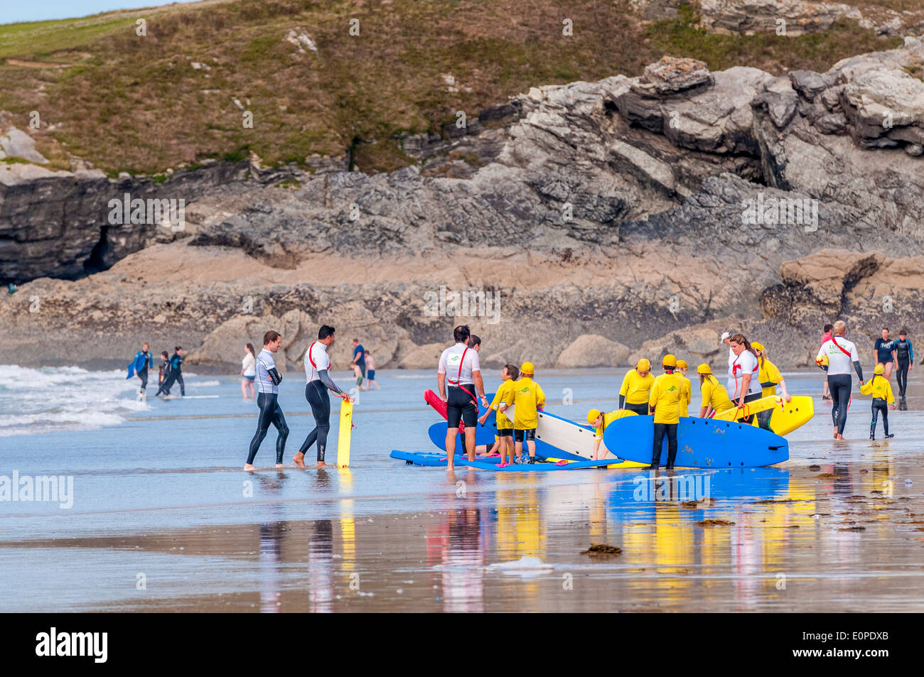 Learning to surf in the UK on the beach in Newquay England on a sunny ...