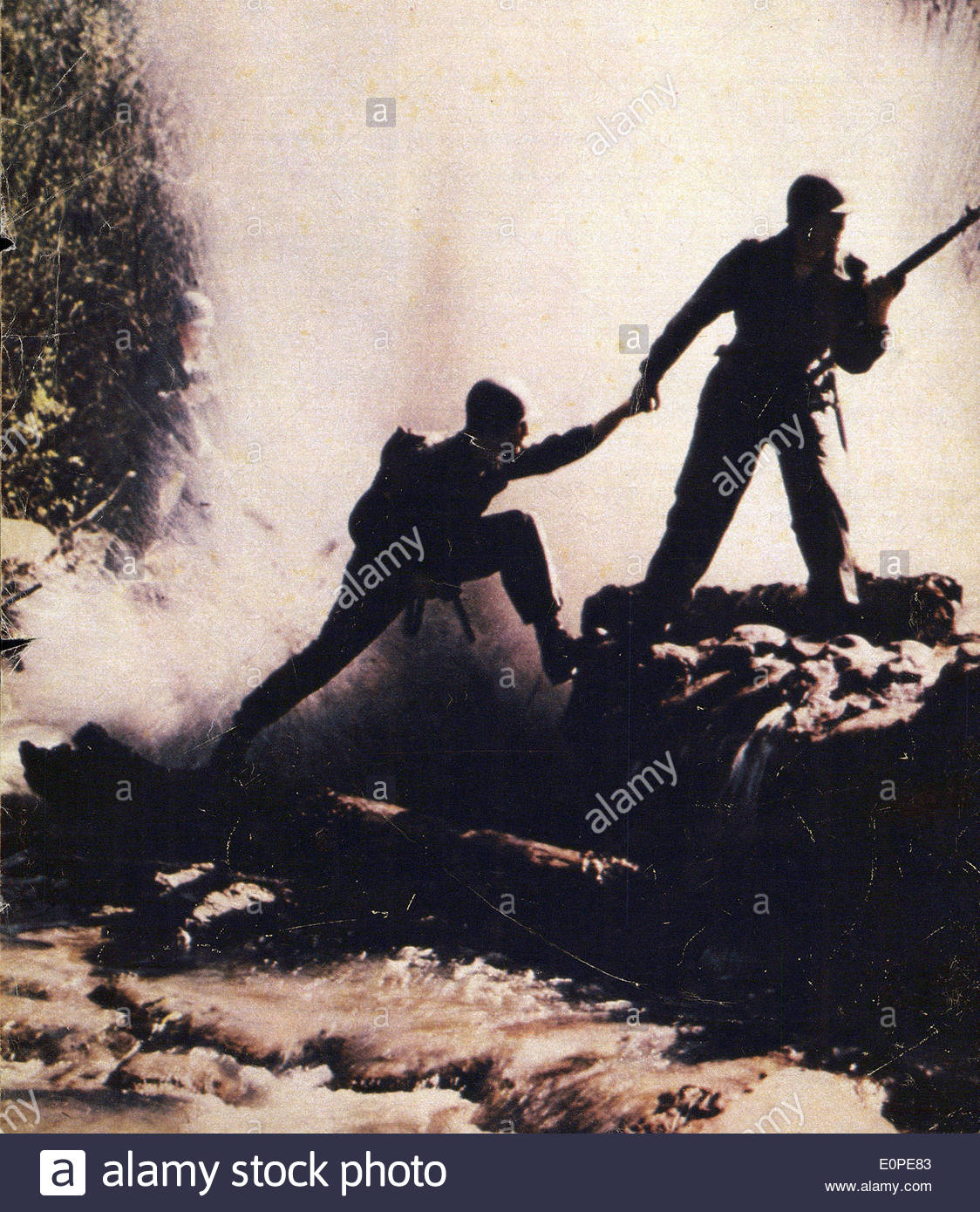 Two unknown soldiers helping each other on the battlefield during Stock ...