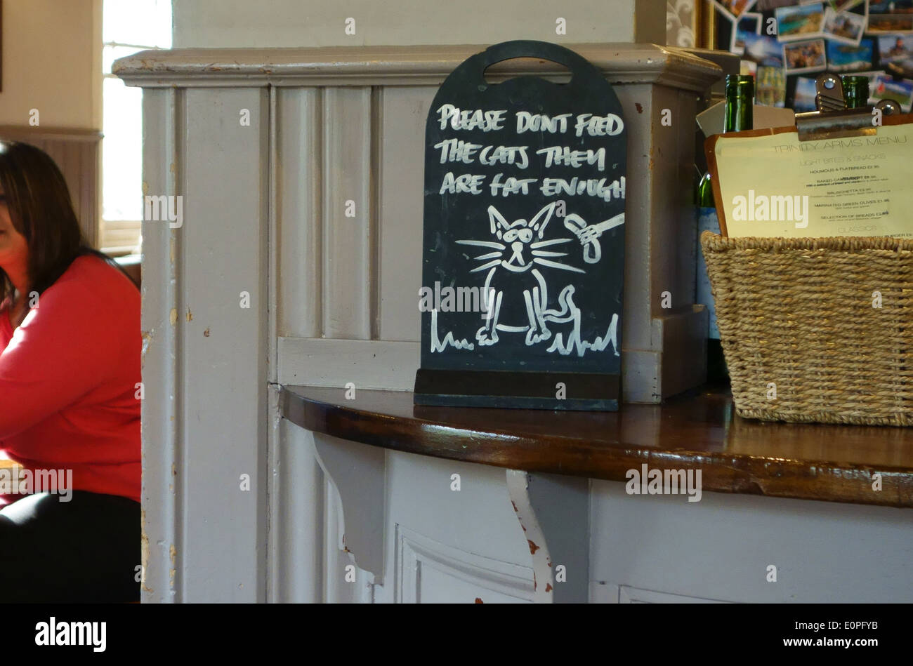 Fat cats: humorous sign about feeding the cats in a London pub Stock ...