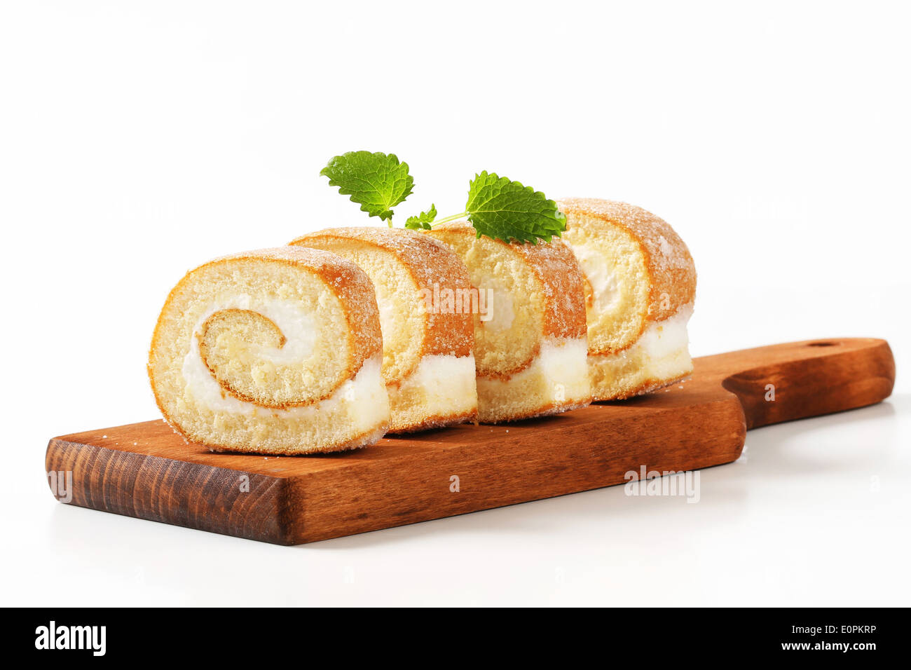 Sponge cake roll with cream filling Stock Photo - Alamy