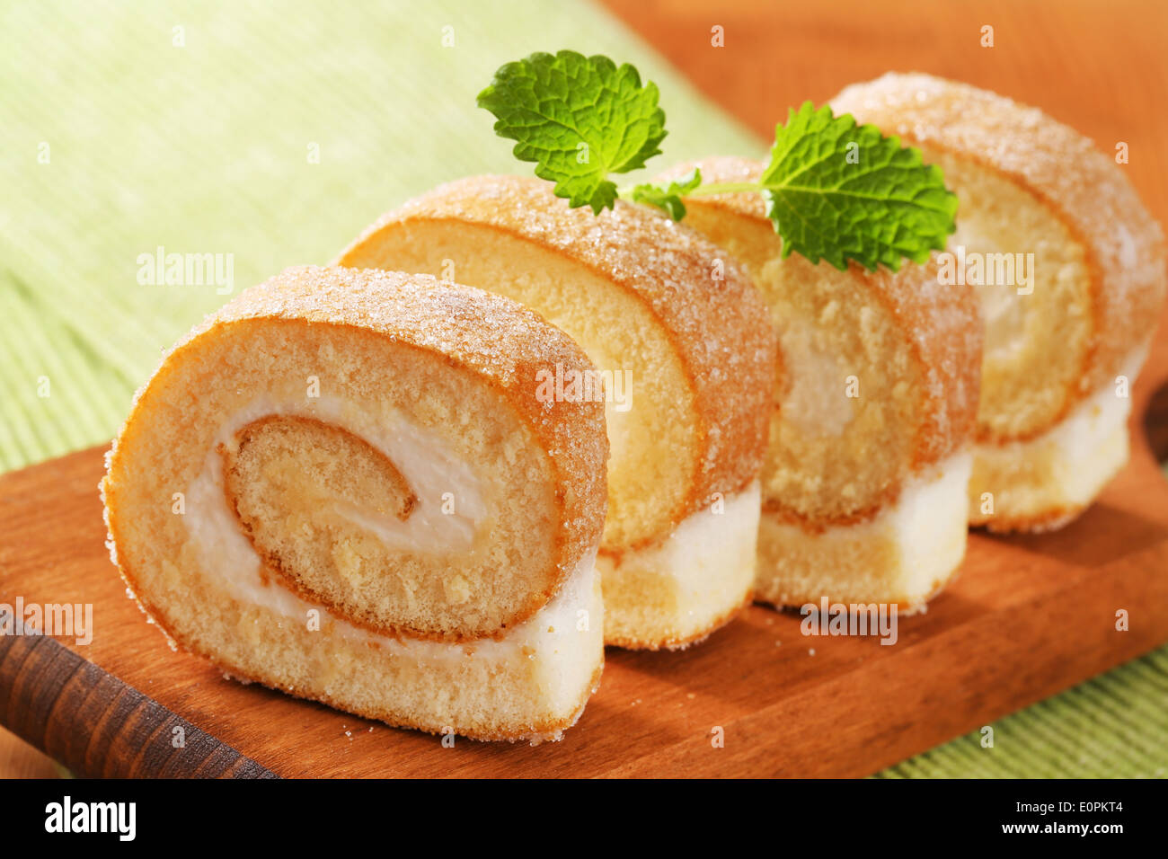 Sponge cake roll with cream filling Stock Photo - Alamy
