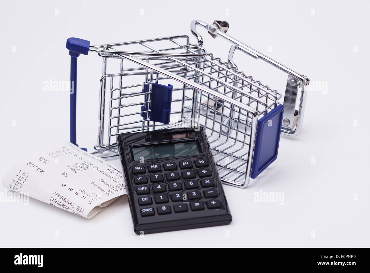 Shopping till receipt calculator and cart Stock Photo - Alamy