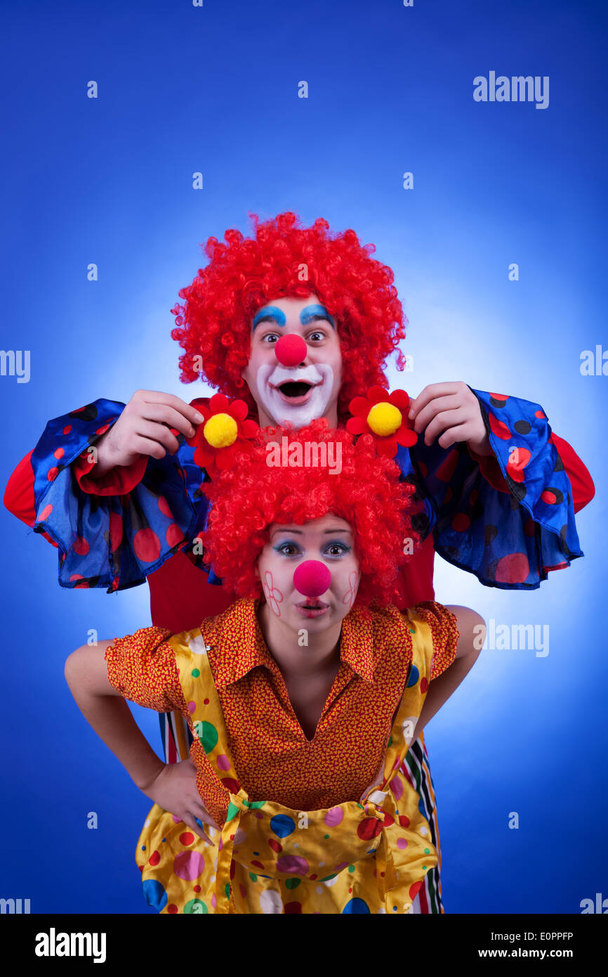Clown couple on blue background. Professional studio lighting Stock ...